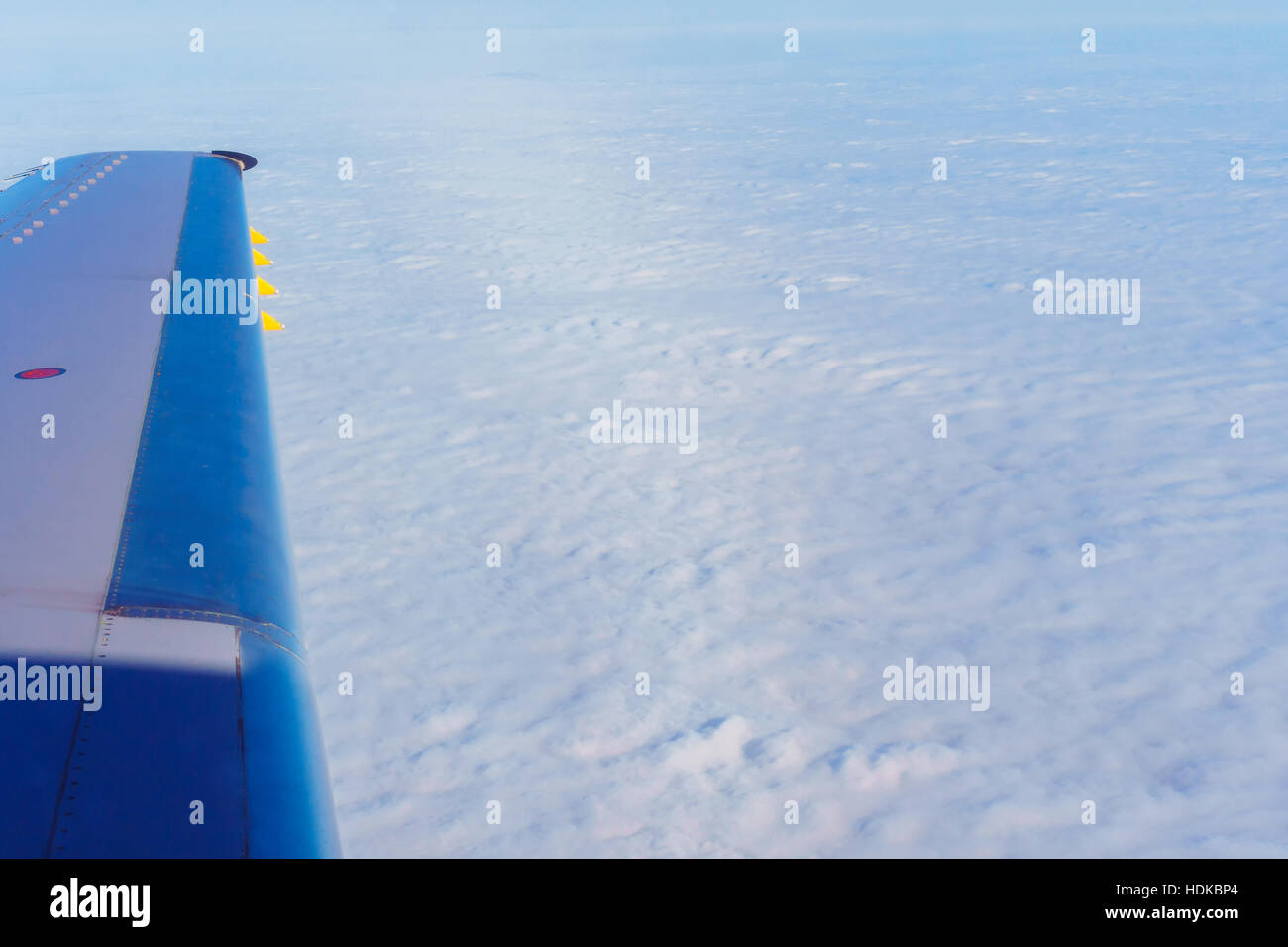 Clouds and sky and Airplane Wing as seen through window of an aircraft ...