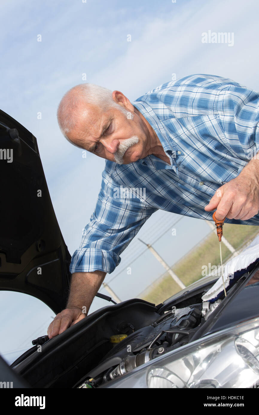 senior man checking car motor levels Stock Photo - Alamy