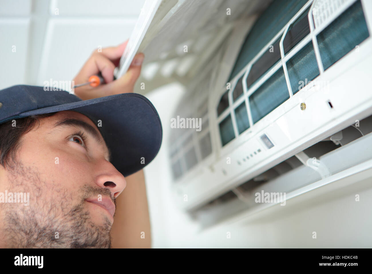 Man inspecting air conditioning unit Stock Photo - Alamy