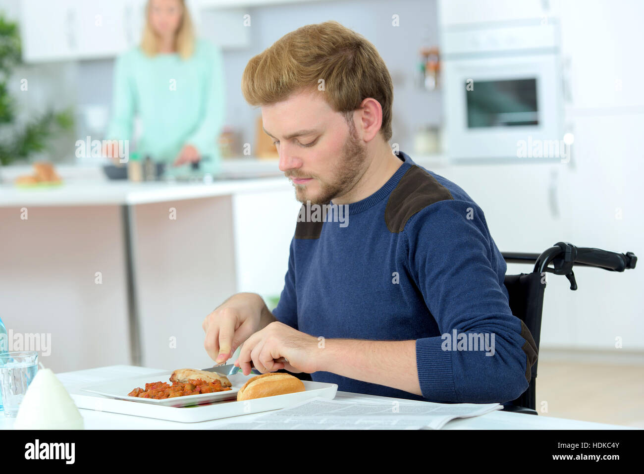disabled man eating a meal Stock Photo - Alamy