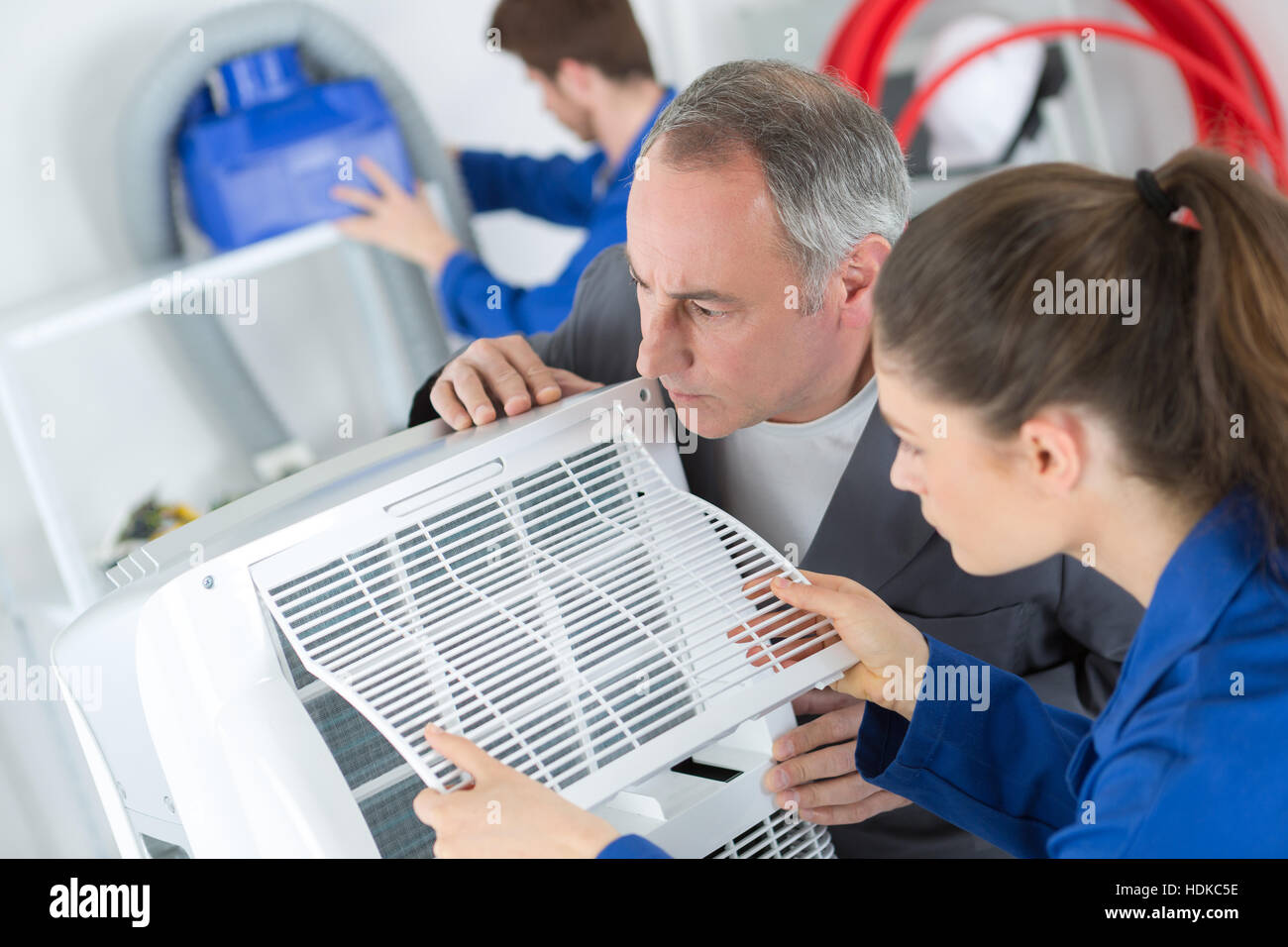 Students working on air conditioning unit Stock Photo - Alamy