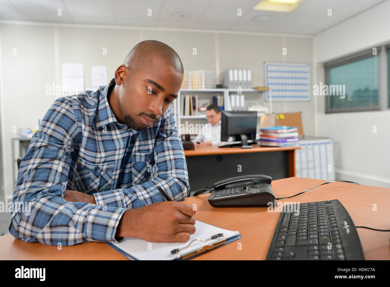 Office worker at his desk Stock Photo - Alamy