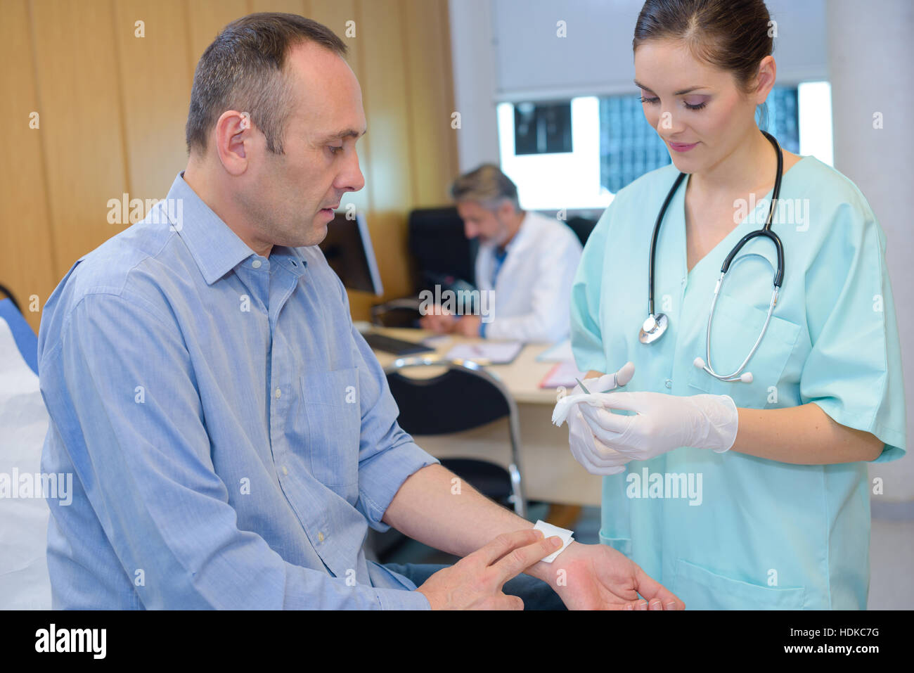 medical assistant putting a dressing Stock Photo - Alamy