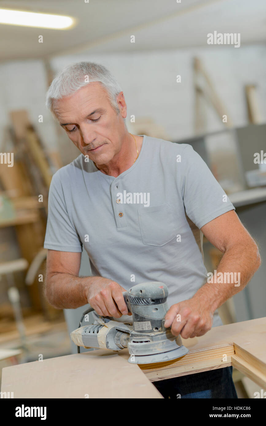 Man using circular sander Stock Photo - Alamy