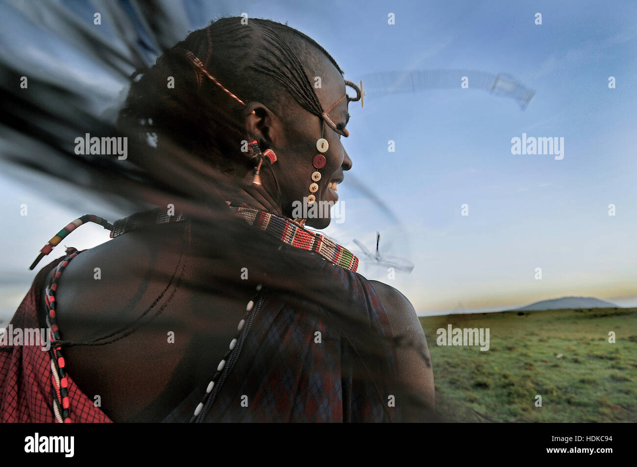 A Happy Maasai Warrior Tribesman with Traditional Braids Flying in the ...