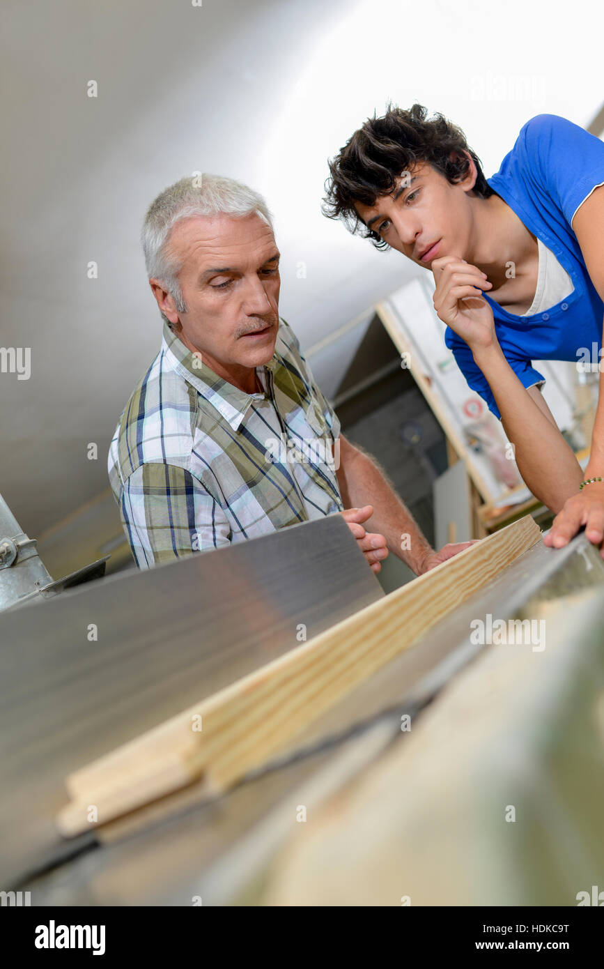 Craftsman giving instructions to his apprentice Stock Photo - Alamy