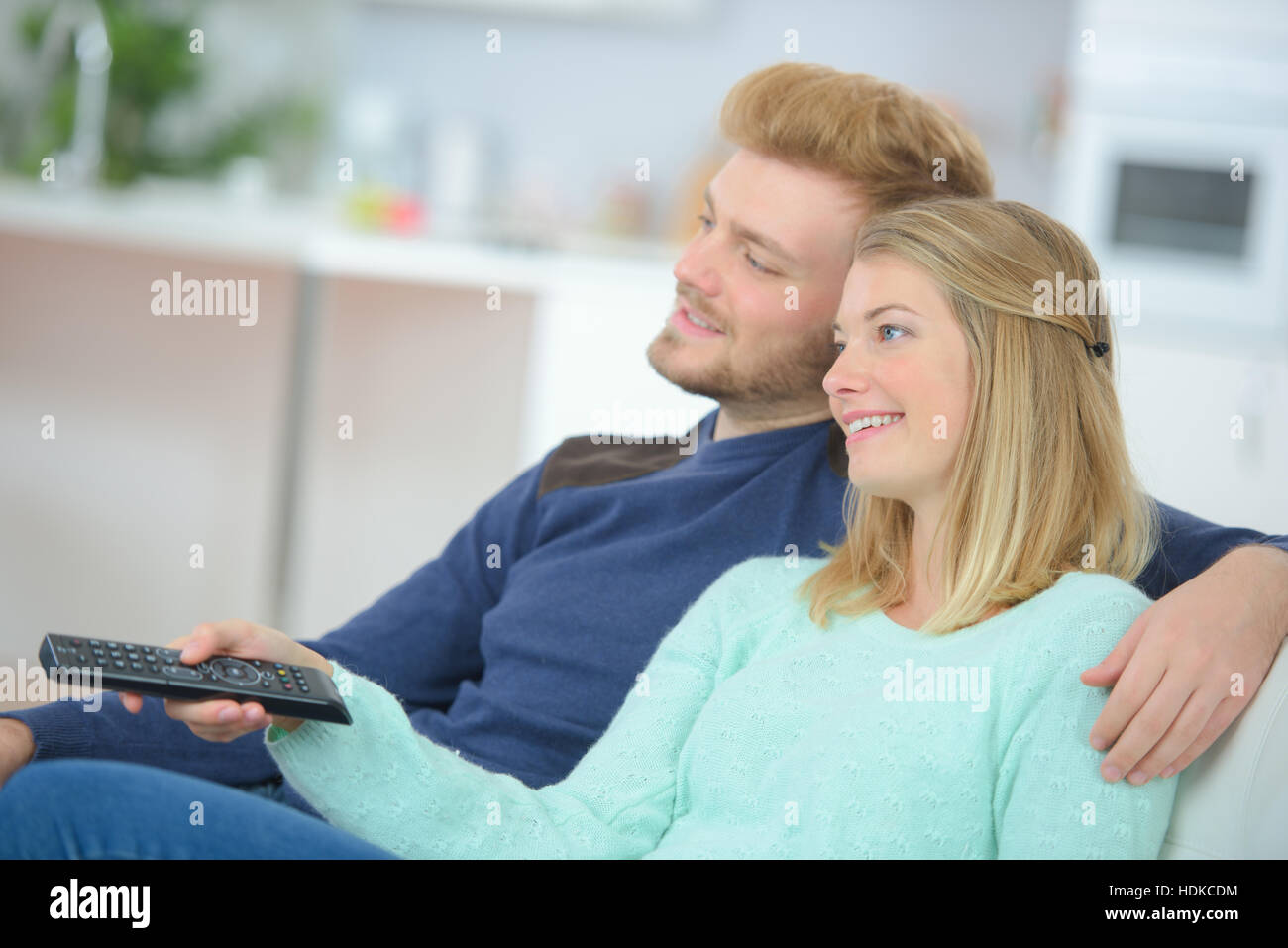Couple watching tv at home Stock Photo - Alamy