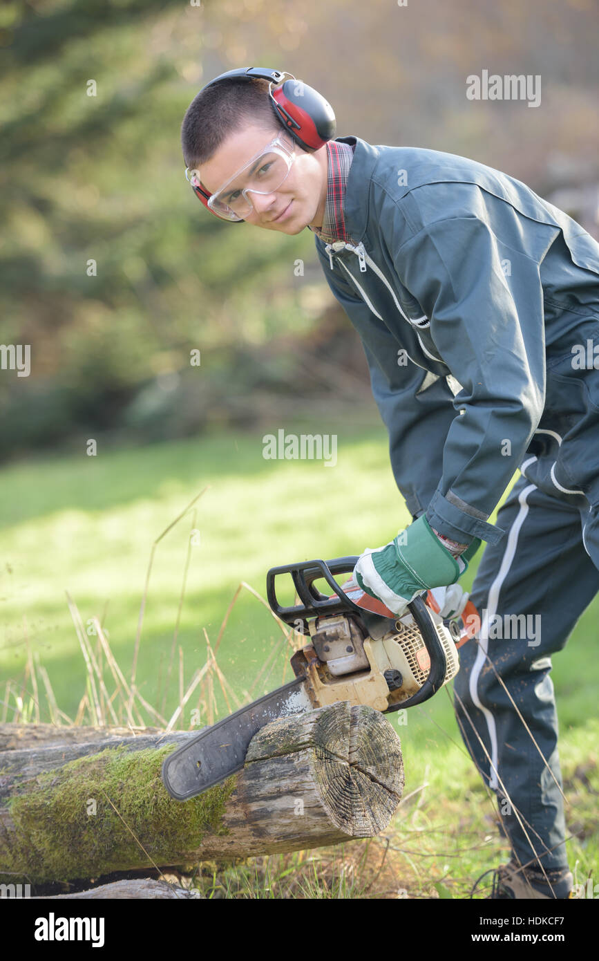 man cutting a log Stock Photo - Alamy