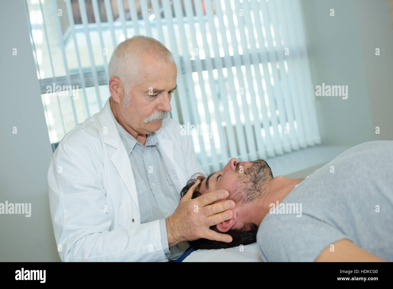 Doctor massaging patient's head Stock Photo - Alamy