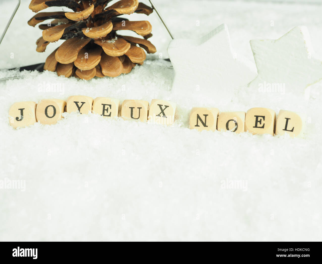 Wooden dices with the words Joyeux Noel in snow, French Merry christmas ...