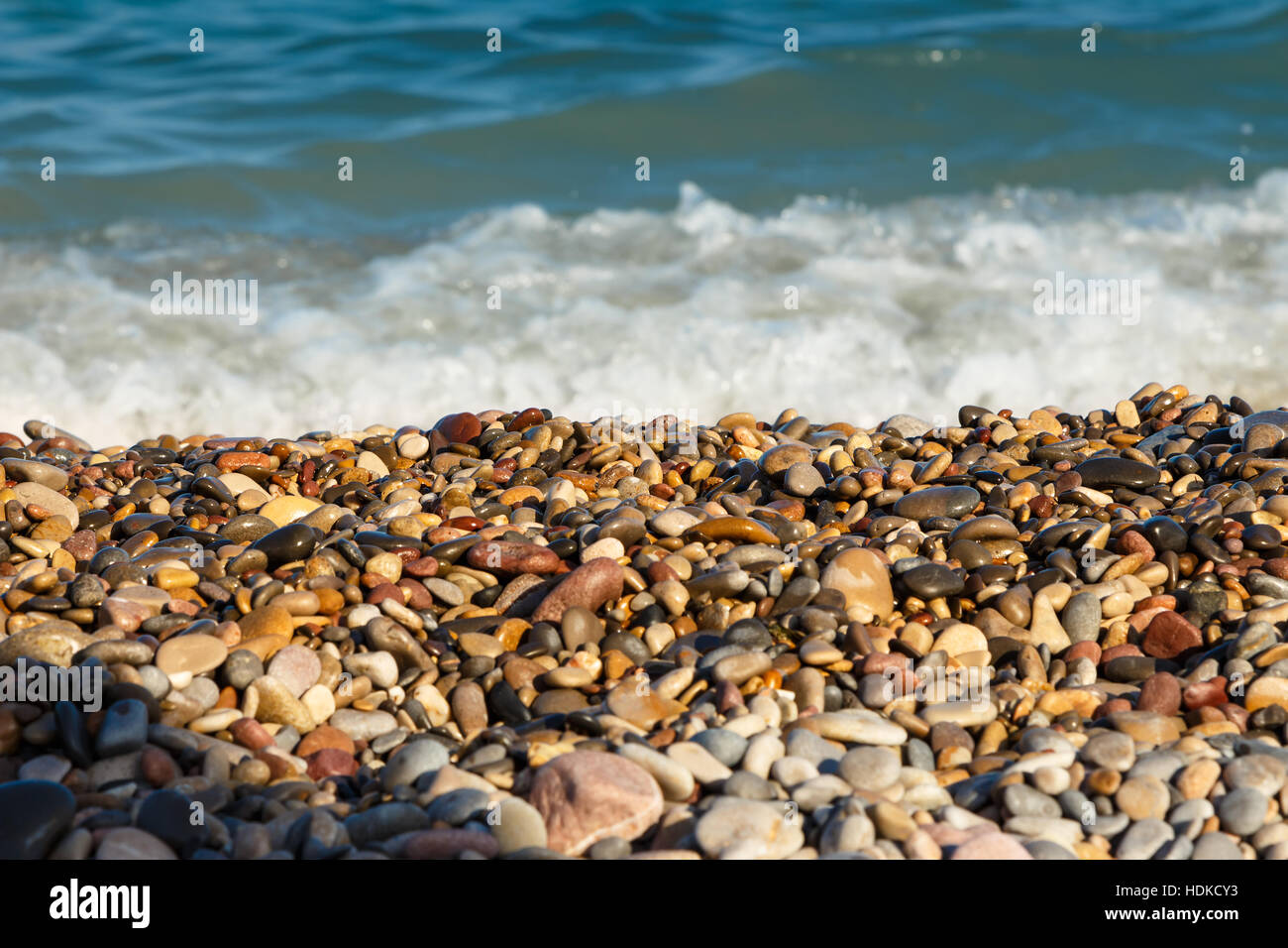 Sea shore with round stones on the mediterranean coast. Horizontal ...