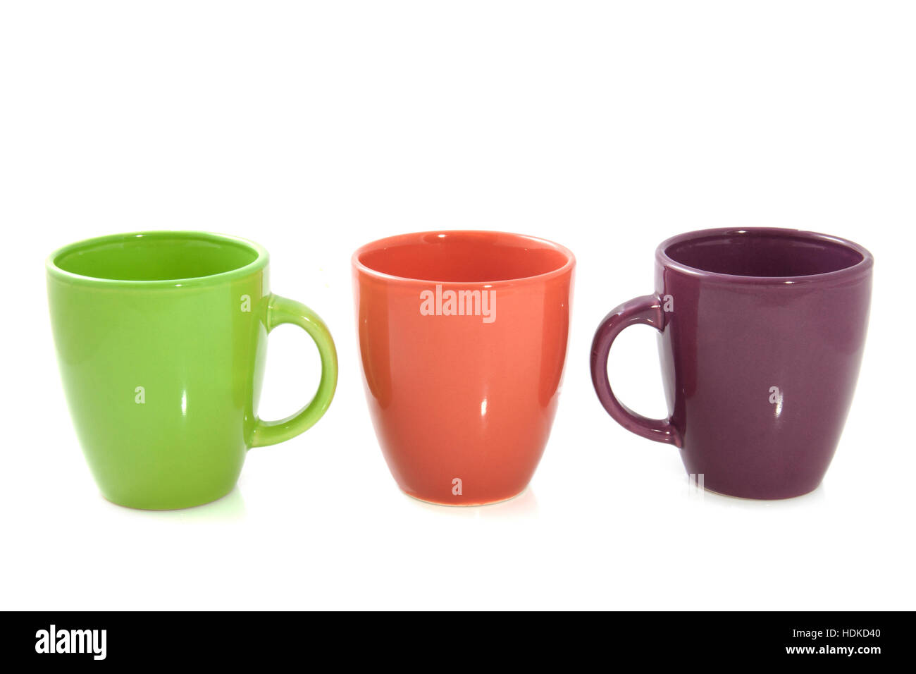 Colorful cups in a row isolated over white Stock Photo - Alamy