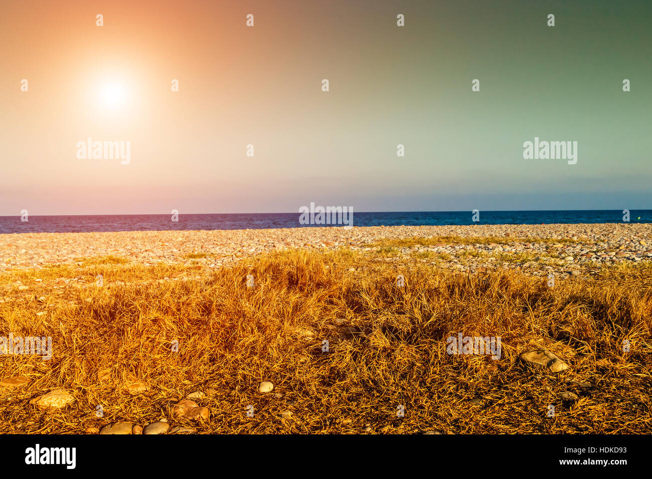 Sunset on the beach with the sea in the background. Horizontal image ...