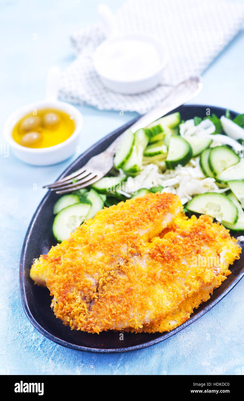fried fish on plate and on a table Stock Photo - Alamy