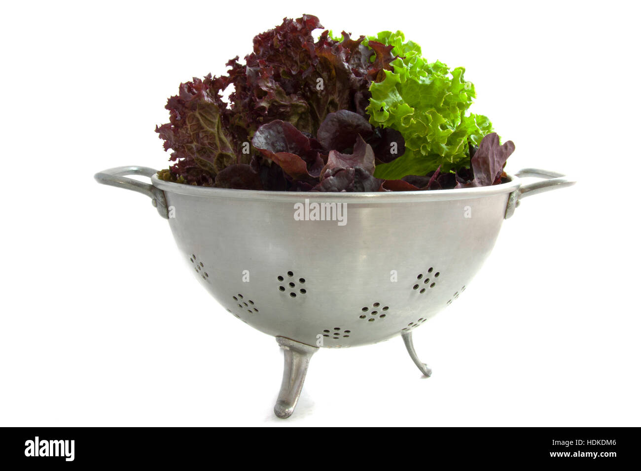 Red and green salad in silver sieve isolated over white Stock Photo - Alamy
