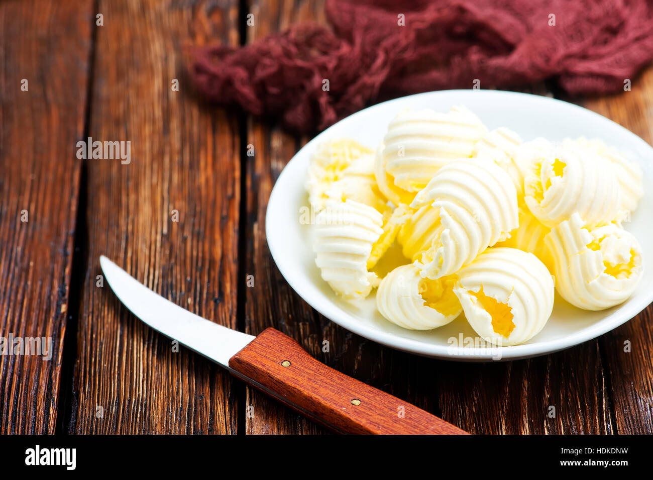 fresh butter on plate and on a table Stock Photo - Alamy
