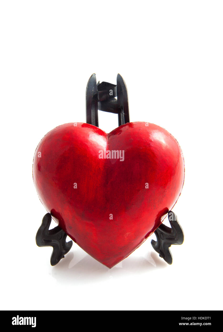 Red heart in black stand isolated over white Stock Photo - Alamy