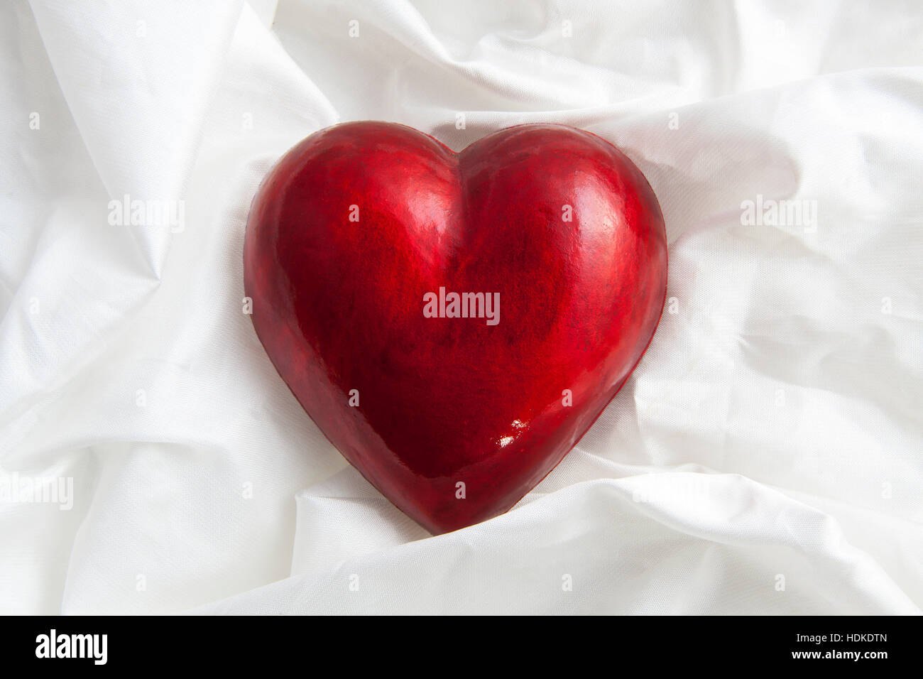 Big red heart on satin for background use Stock Photo - Alamy