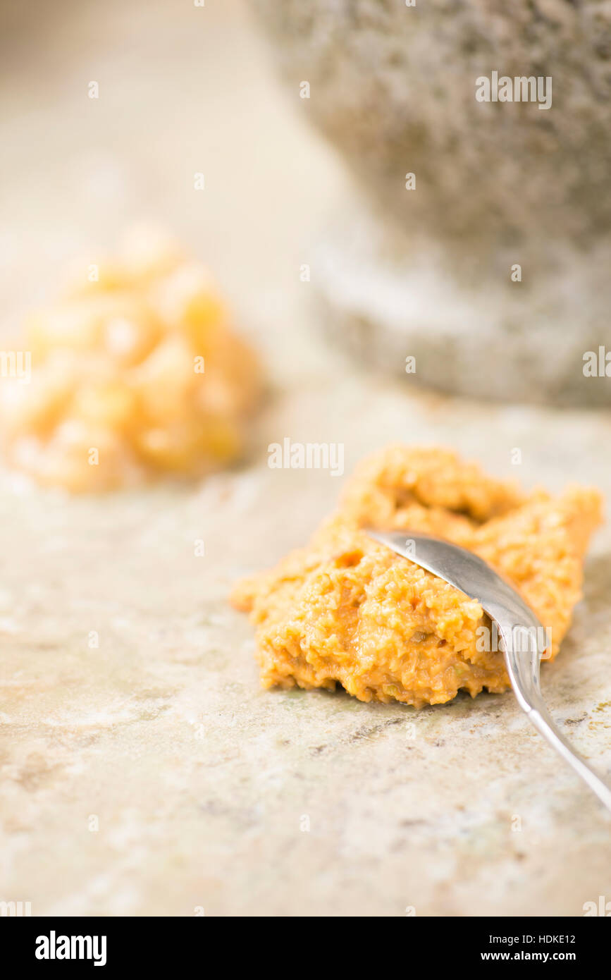 Red guacamole with avocado and tomato in close up Stock Photo - Alamy