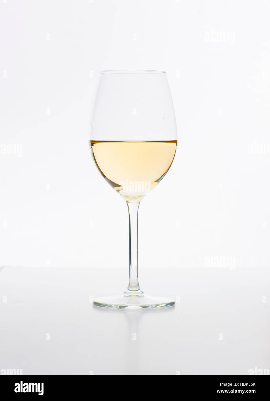 White wine in glass on table Stock Photo - Alamy