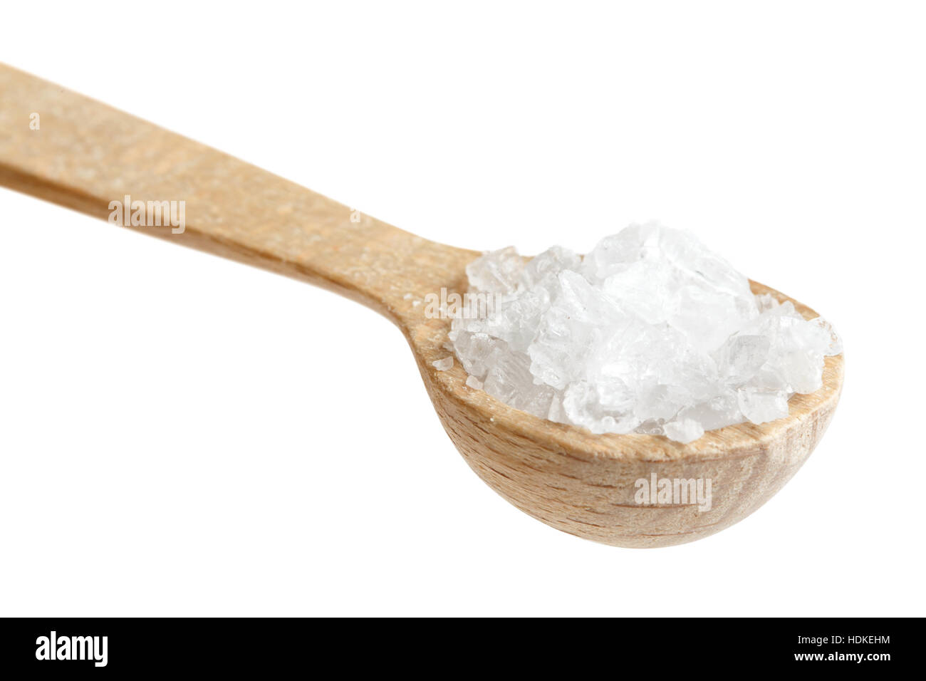 Small wooden spoon of coarse salt isolated on white Stock Photo - Alamy