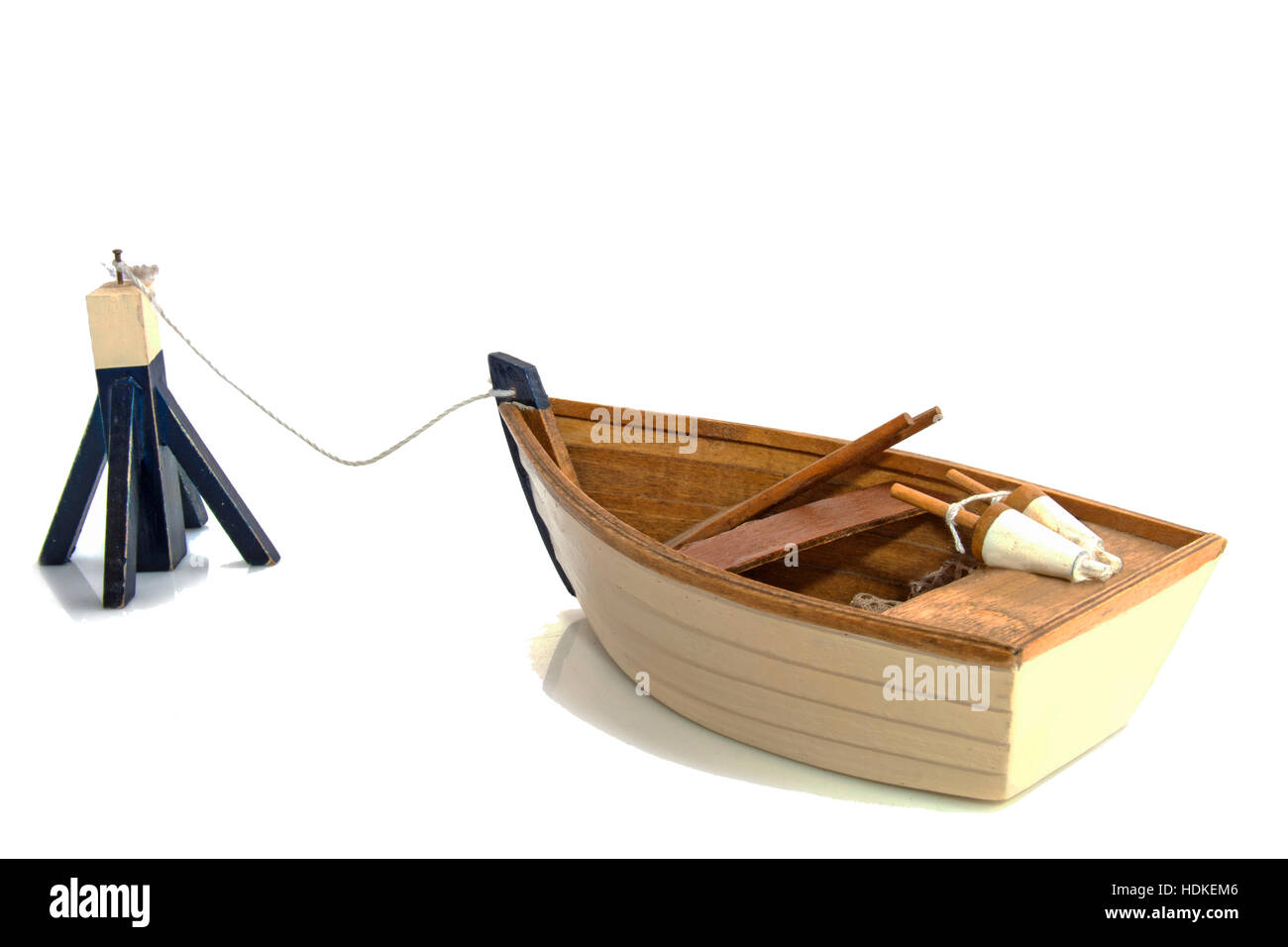 Small old wooden boat with buoy isolated over white Stock Photo - Alamy