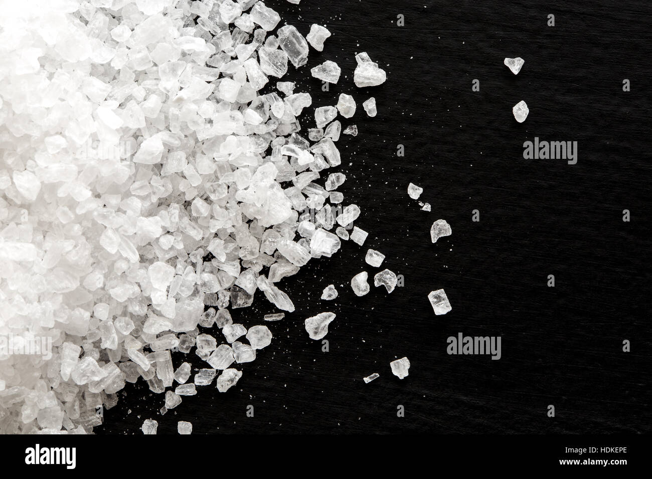 Heap of coarse salt on black from above Stock Photo - Alamy