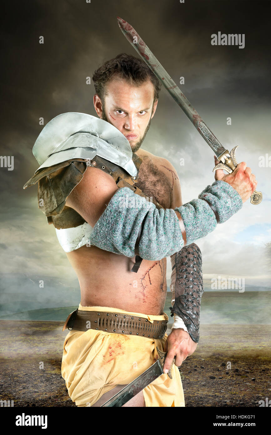 Ancient warrior or Gladiator posing outdoors with swords Stock Photo ...