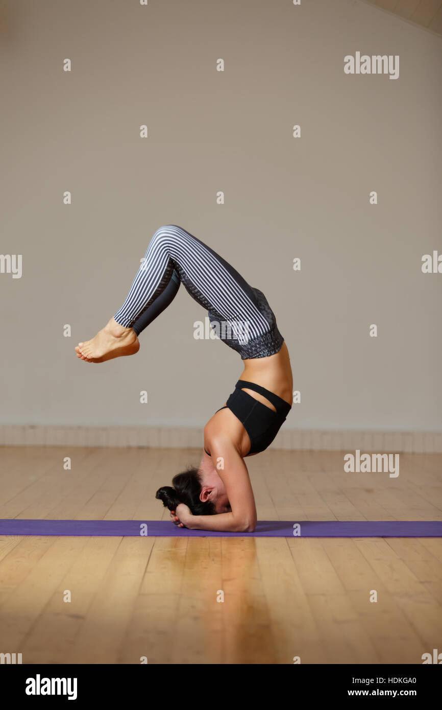 Girl doing exercises on head Stock Photo - Alamy