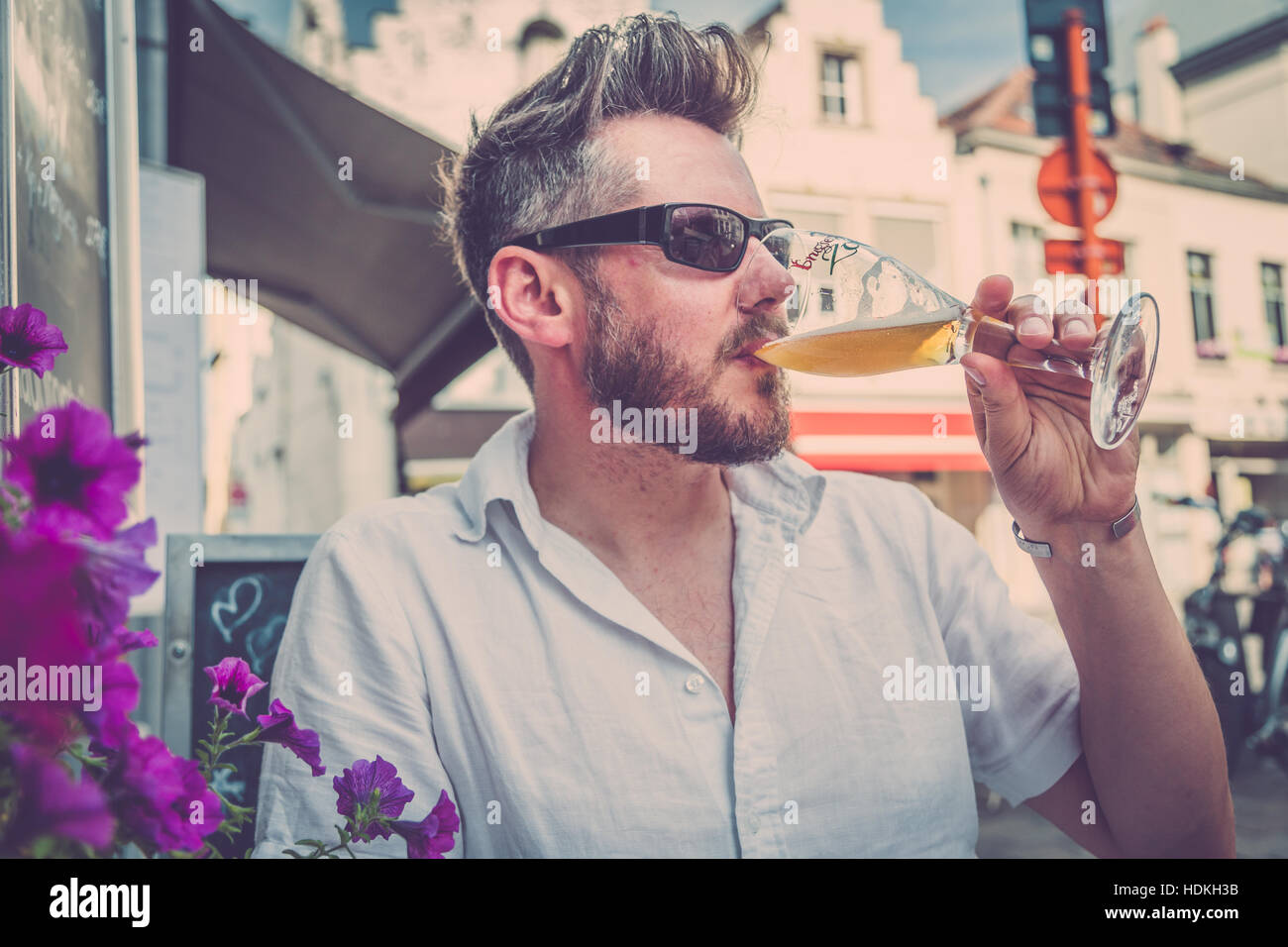 Man drinking beer in Continental cafe outside in summer Stock Photo - Alamy