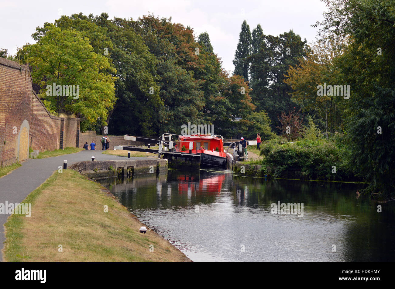 Canal boat in the lock at Hanwell with people working the lock gates ...