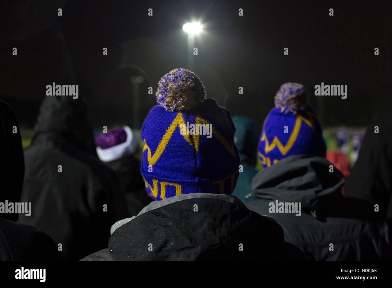 Home supporters in bobble hats watching the closing stages of the match ...