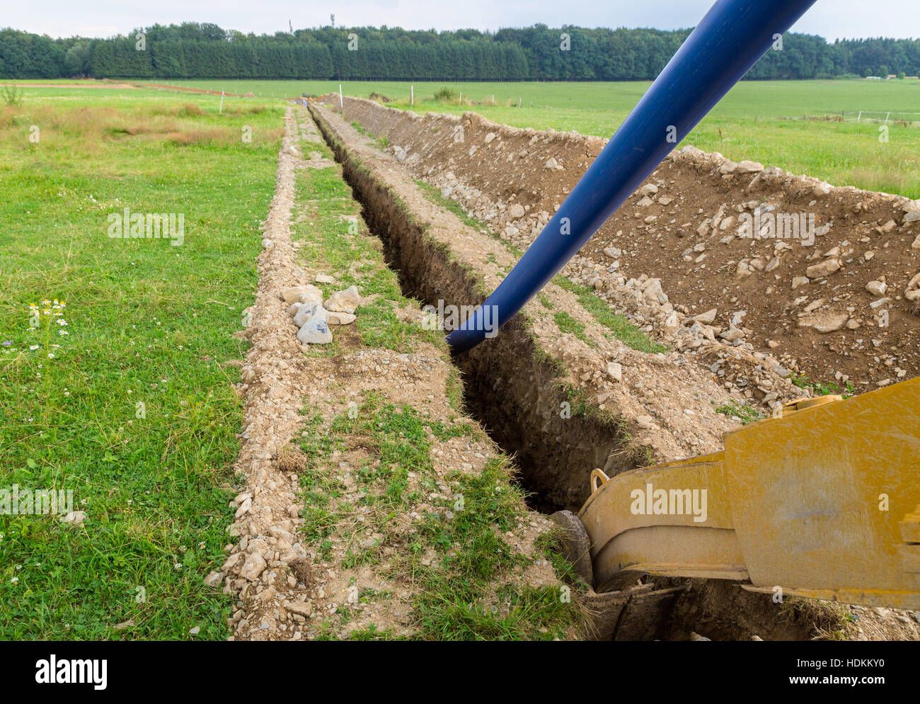 Pipe laying construction site on a meadow Stock Photo - Alamy