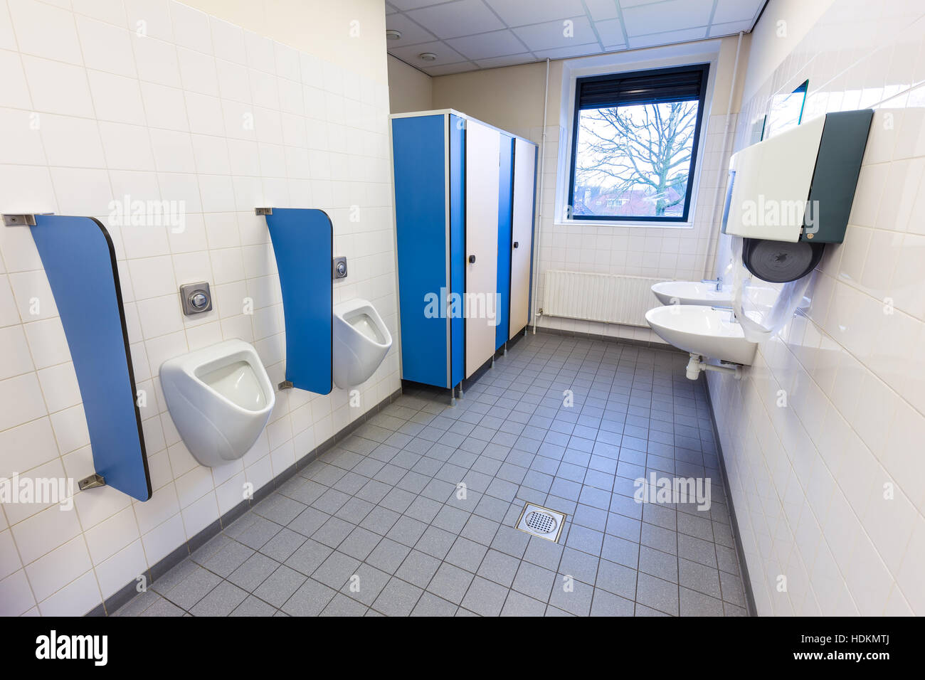 Toilet room for men with urinals sinks and towel dispenser on high ...