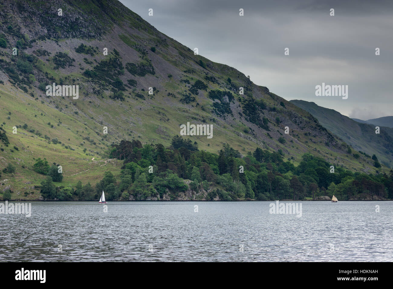 Giant mountain slope descends into lake Stock Photo - Alamy