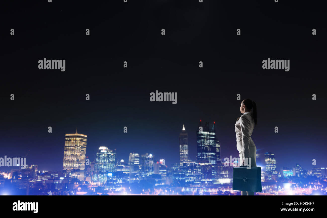 Woman looking at night city Stock Photo - Alamy