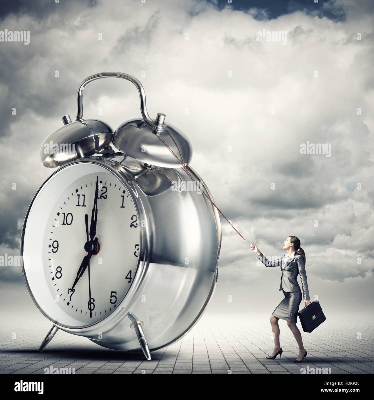 Woman controlling time Stock Photo - Alamy