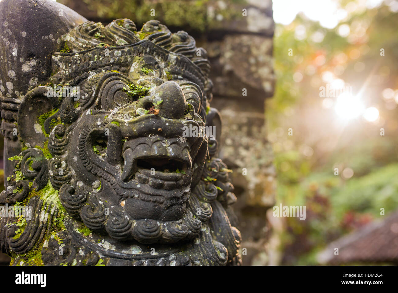 Traditional guard demon statue carved in dark stone on Bali island ...