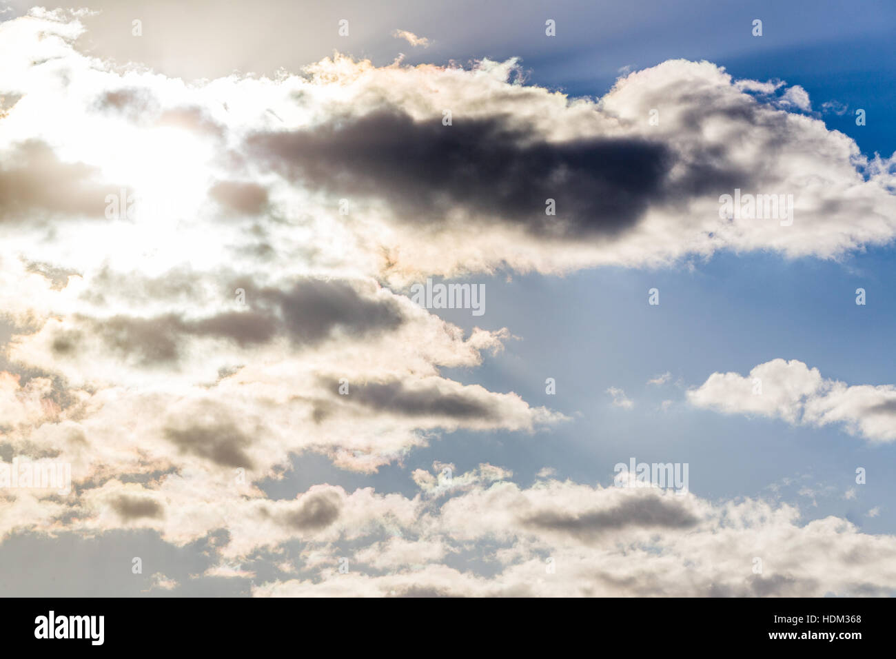 Backlit blue sky with dark clouds Stock Photo - Alamy