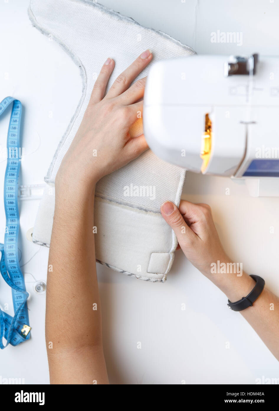 Girl tailoring boot on sewing-machine Stock Photo - Alamy
