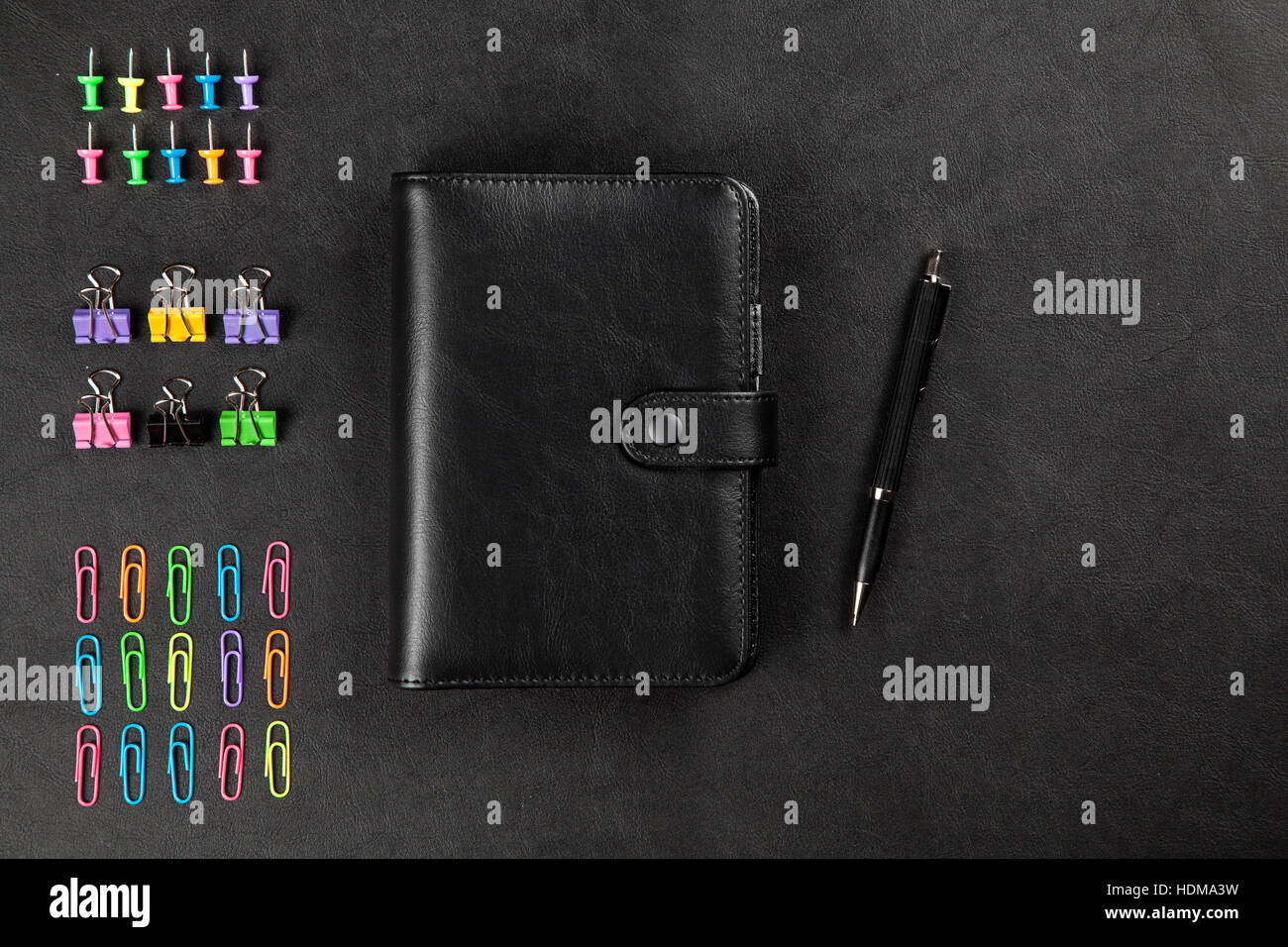 Office supplies on a black table Stock Photo - Alamy