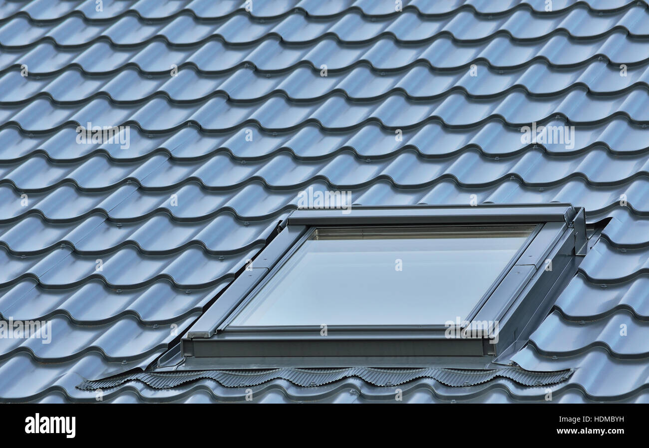 Roof window on a gray tiled rooftop, large detailed loft skylight ...