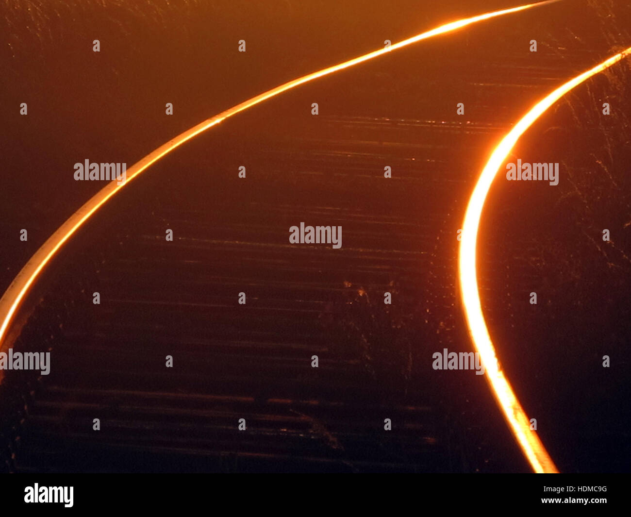 Train tracks illuminated by setting sun Stock Photo - Alamy