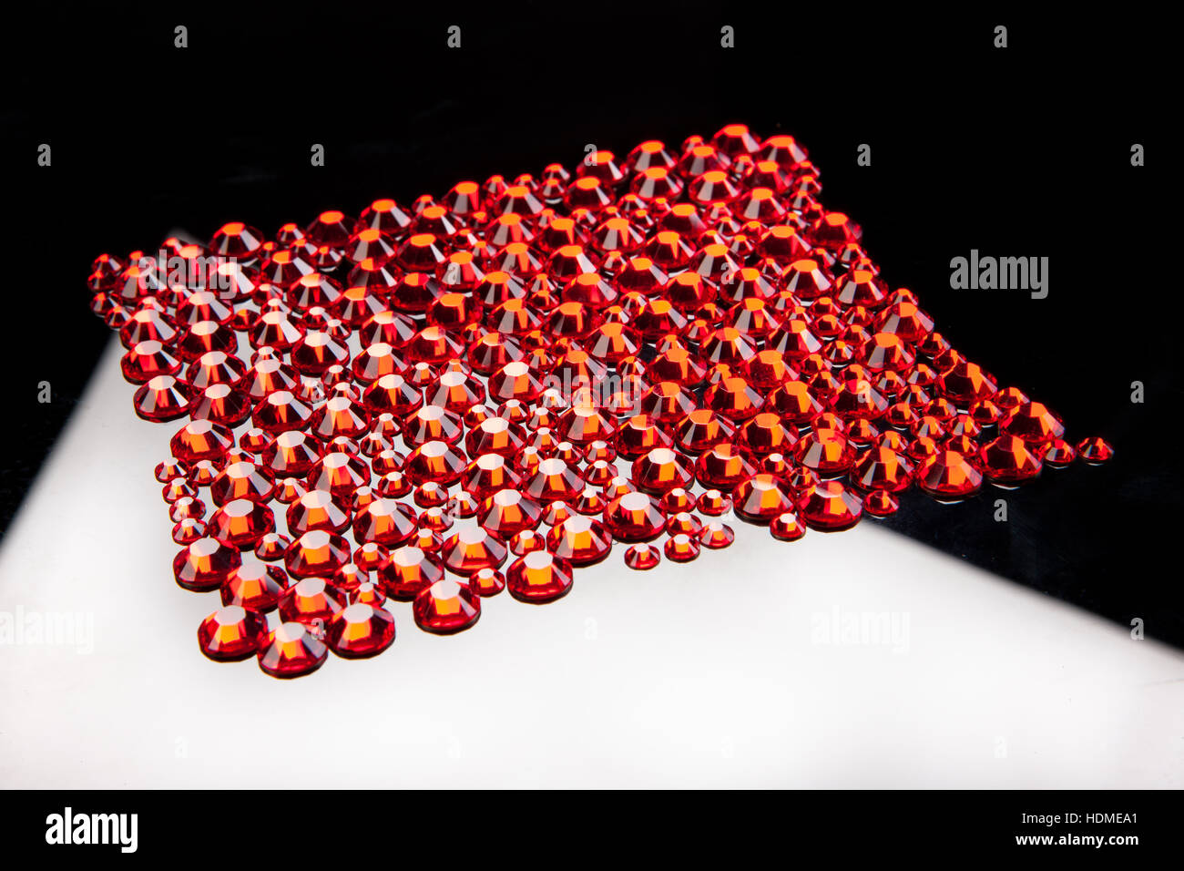 Red crystals on a glass studio background Stock Photo - Alamy