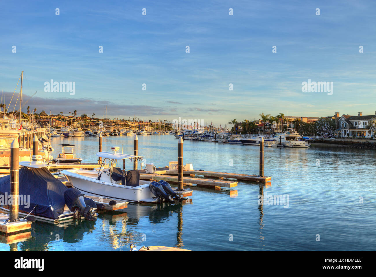 Balboa Island harbor at sunset with ships and sailboats visible from ...