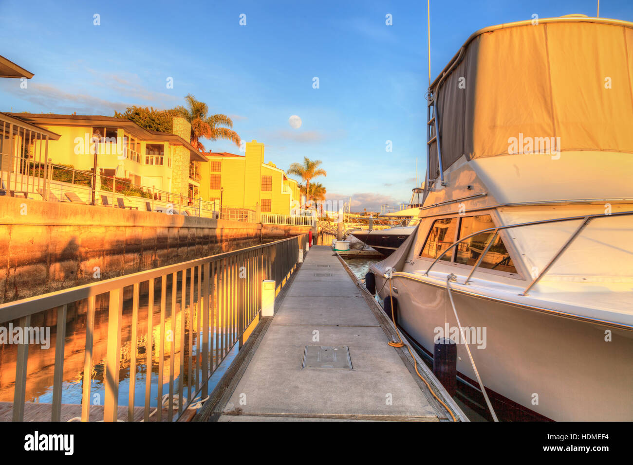 Balboa Island harbor at sunset with ships and sailboats visible from ...