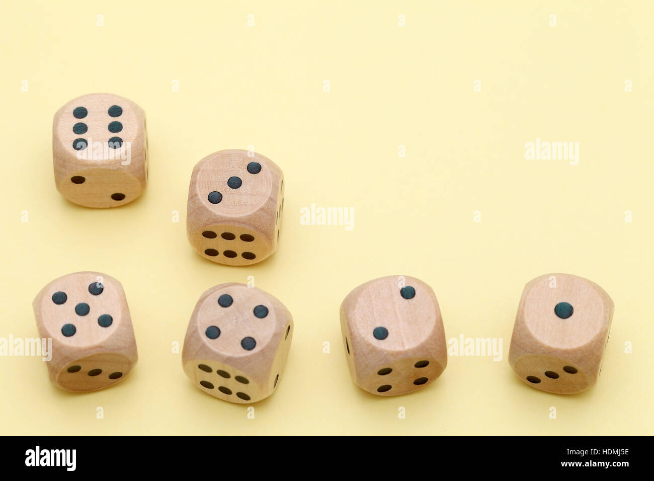 Many wooden dice on a yellow background Stock Photo - Alamy