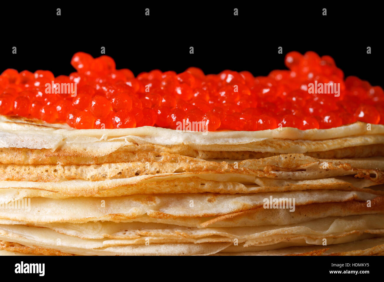 Pile of crepes with red caviar macro isolated on black background Stock ...