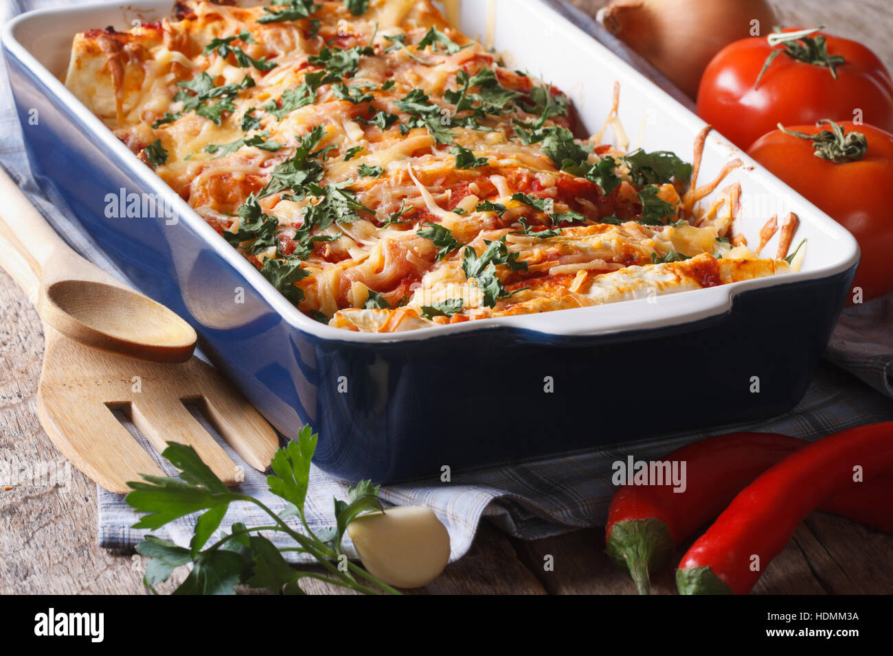 enchilada in baking dish closeup and ingredients on the table ...
