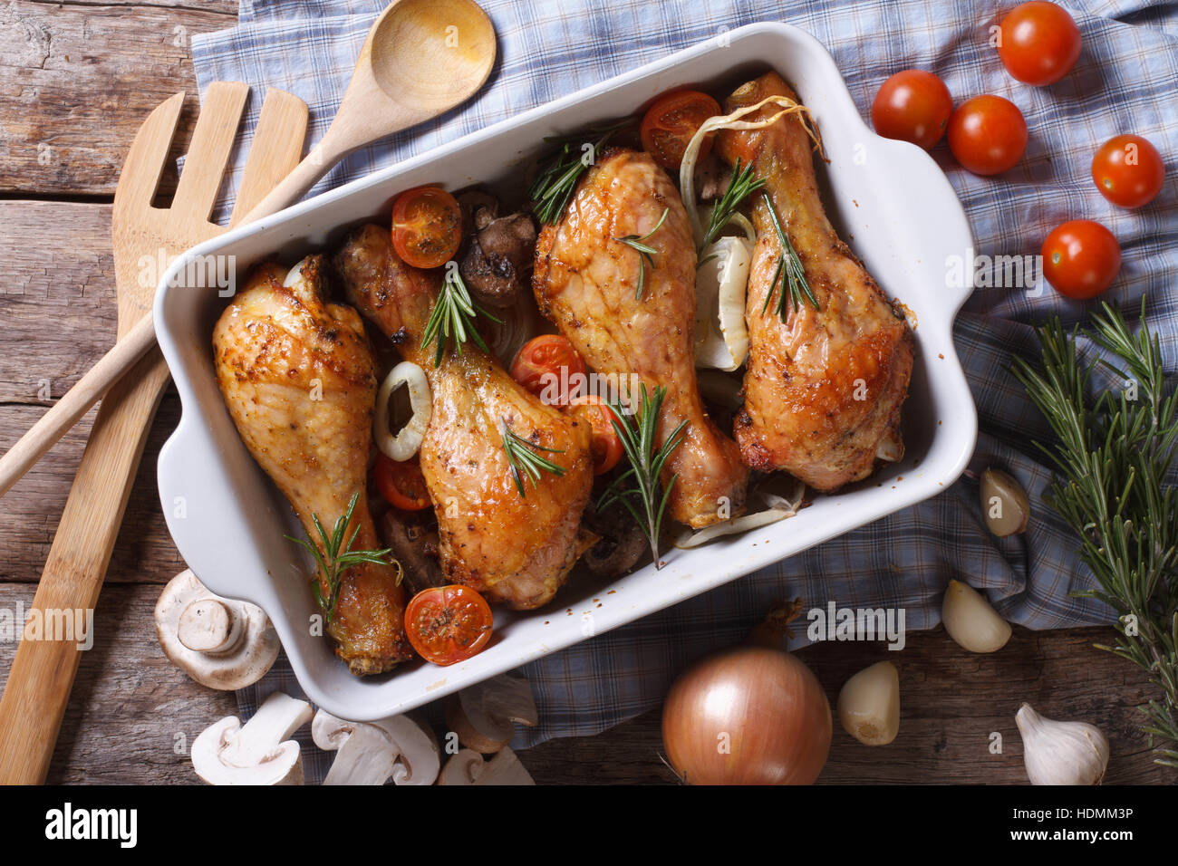 Baked chicken legs with vegetables close-up. horizontal view from above ...